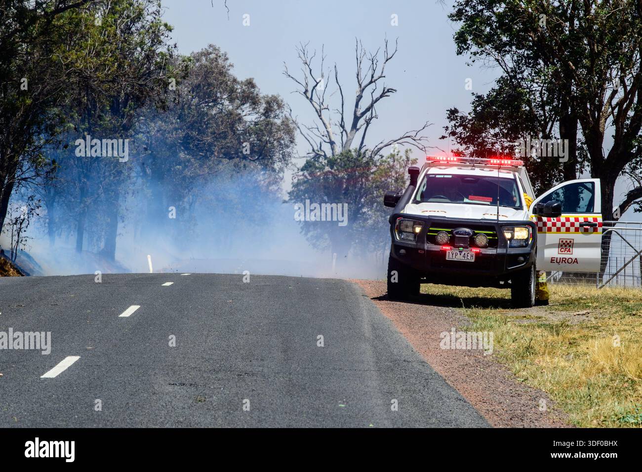 A CFA controler from Euroa on road near Lockwood, Victoria, as smoke ...