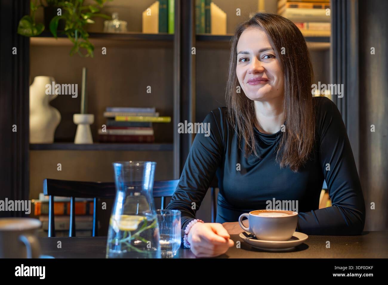 Woman sits table in relaxed hi-res stock photography and images - Alamy