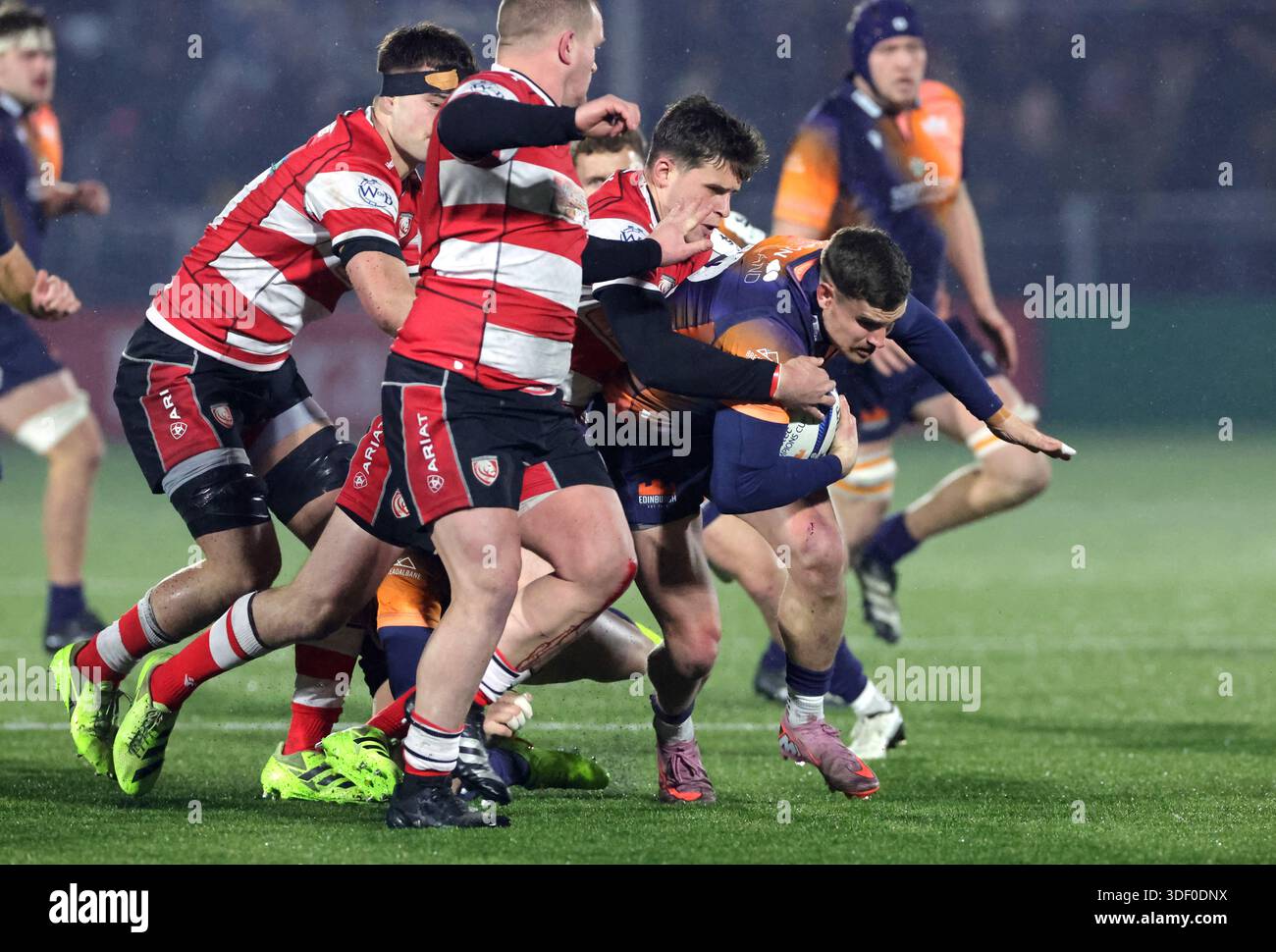 Edinburgh's James Lang is tackled during the Investec Champions Cup ...