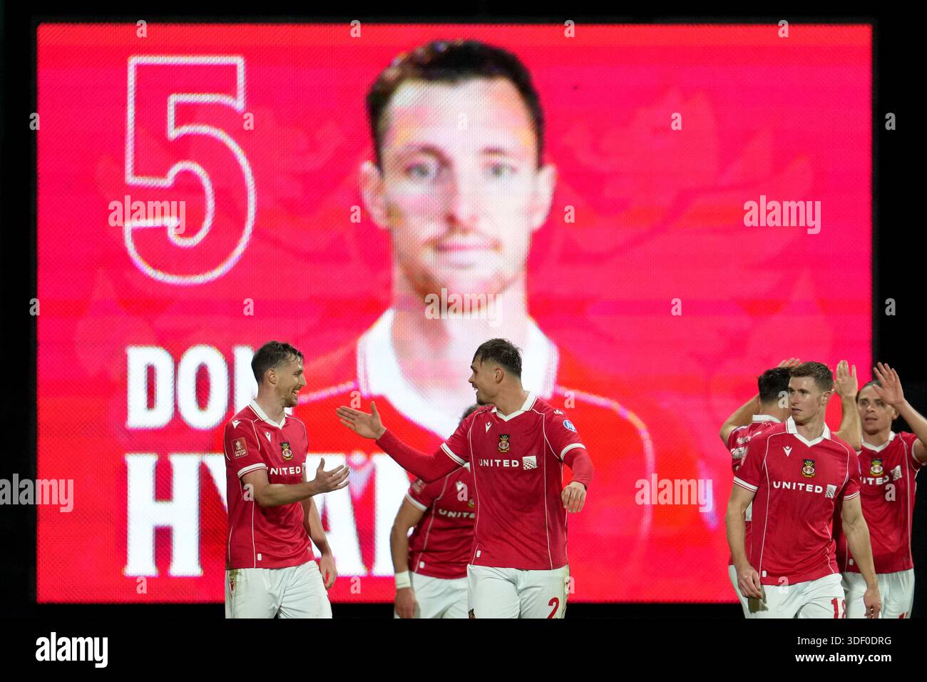 Wrexham's Dominic Hyam, left, celebrates with teammates after scoring ...