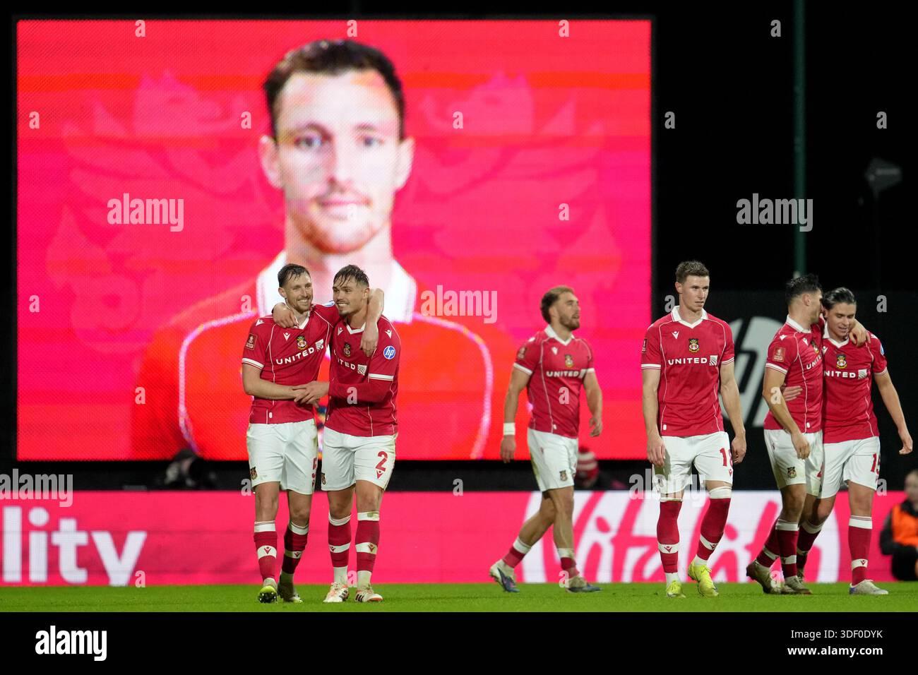 Wrexham's Dominic Hyam, left, celebrates with teammates after scoring ...