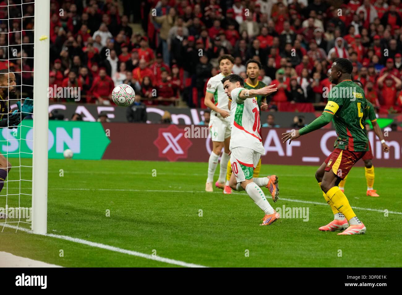 Morocco's Brahim Abdelkader Díaz, right, scores his side's opening goal ...
