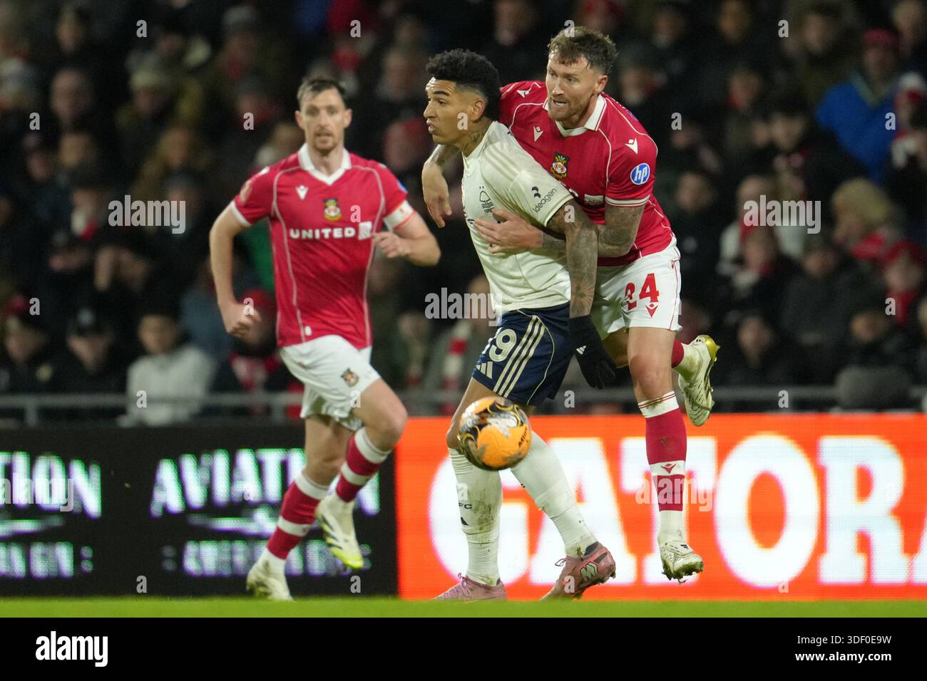 Nottingham Forest's Igor Jesus, center, and Wrexham's Dan Scarr, right ...