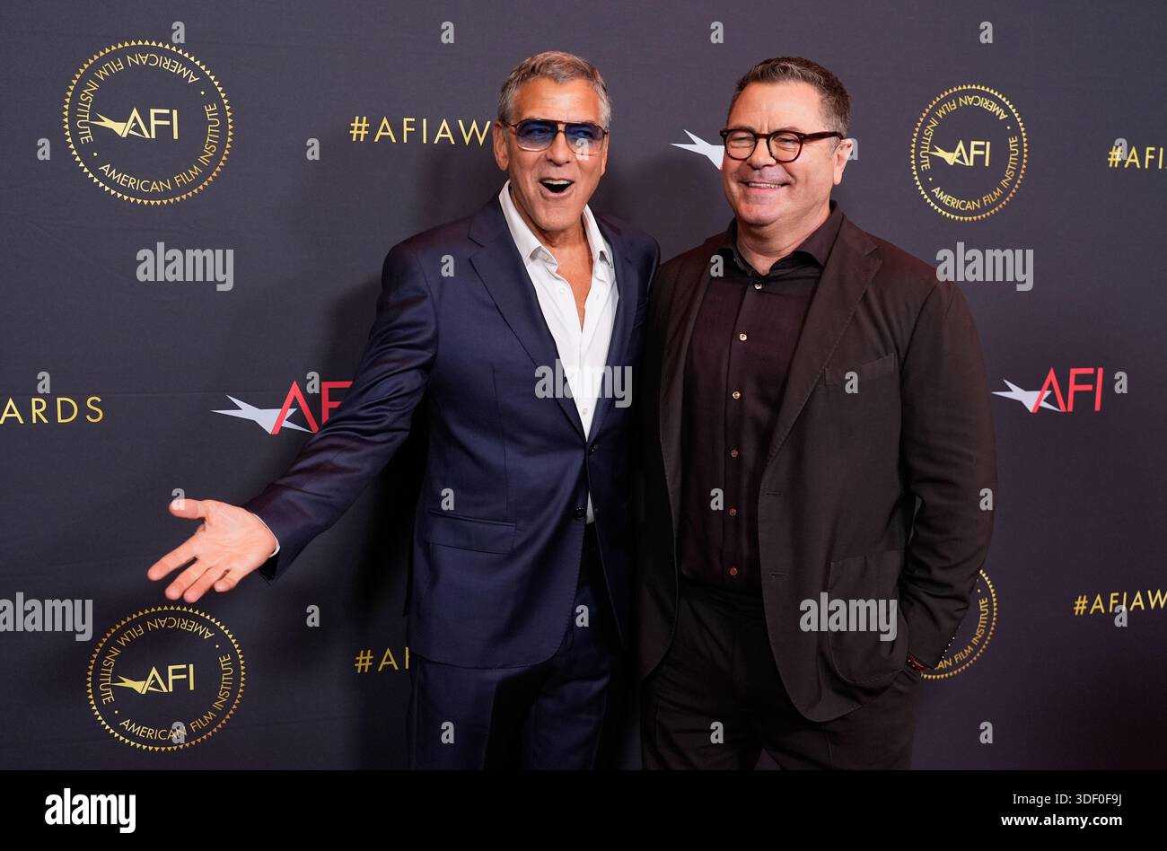Actors George Clooney, left, and Nick Offerman pose together at the AFI ...