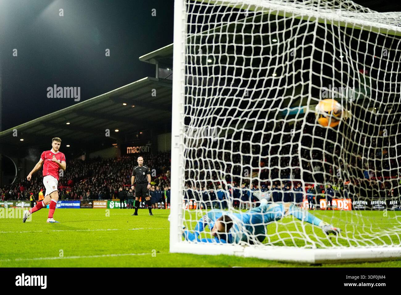Wrexham's George Thomason scores in the penalty shoot-out during the ...