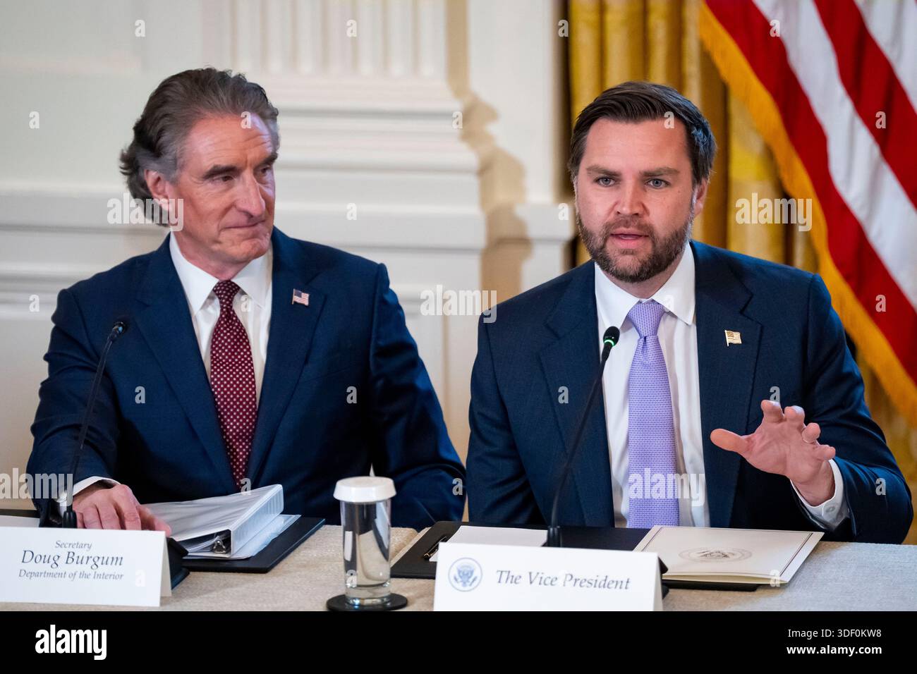 Interior Secretary Doug Burgum looks on as Vice President JD Vance ...
