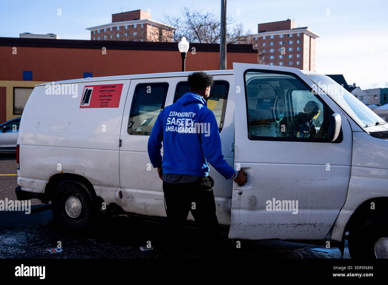 A community outreach worker speaks to a driver in Minneapolis, Friday ...