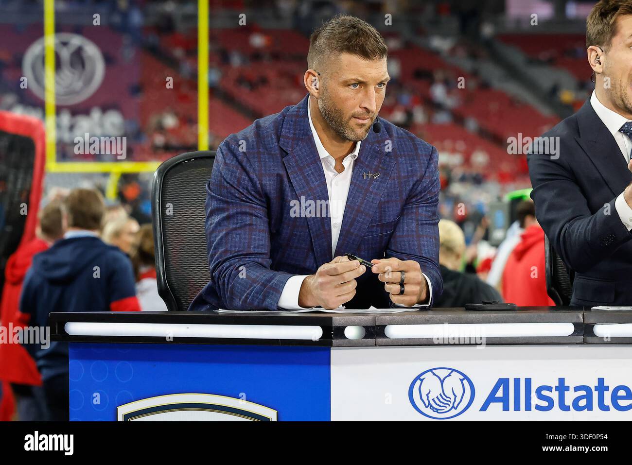 GLENDALE, AZ - JANUARY 08: Sports commentator Tim Tebow looks on before ...