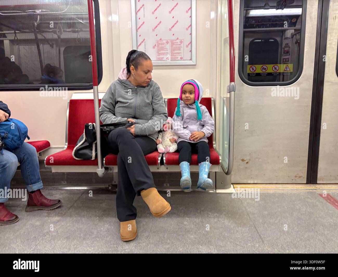 Black mother and daughter on Toronto subway. Metro, underground. Family ...