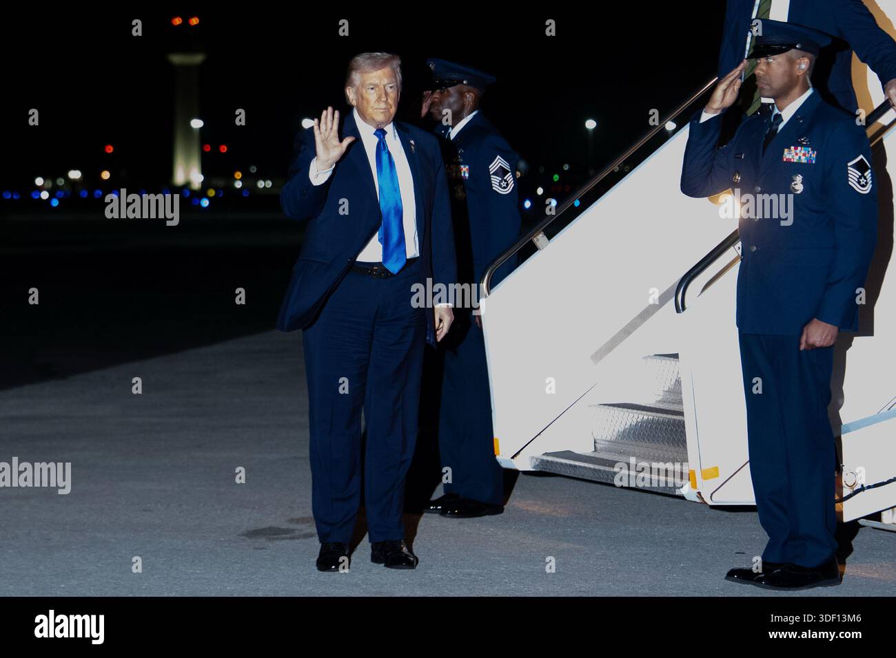 President Donald Trump waves to reporters after arriving on Air Force ...