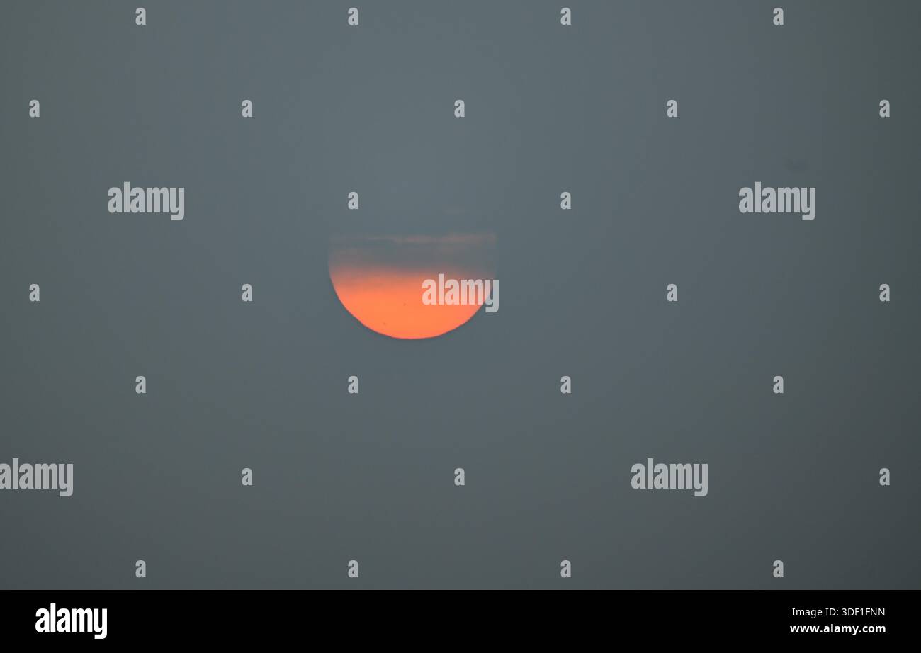 The morning sun rises over mountains as mist lingers in Dingshi Town ...