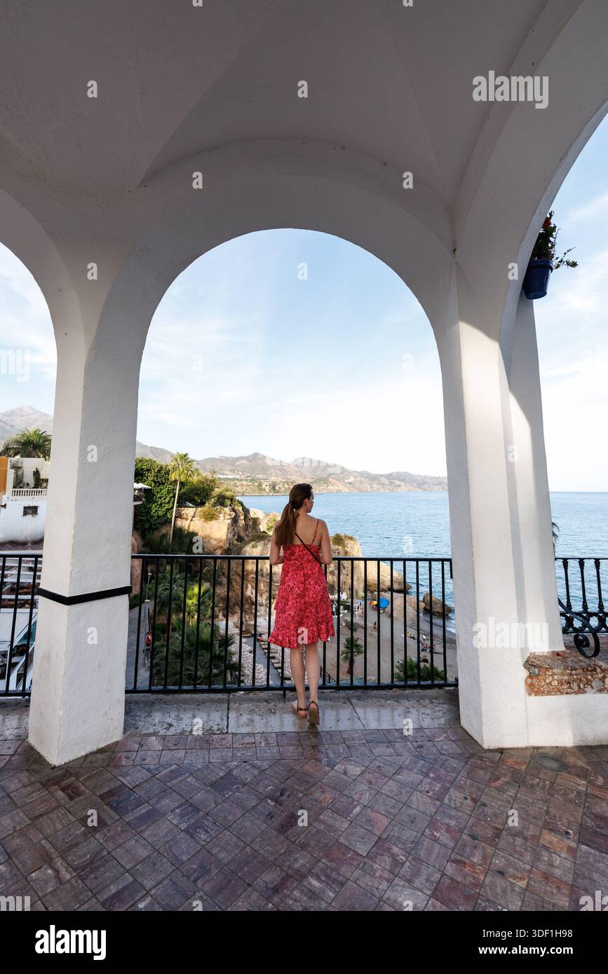 22 September 2025, Spain, Frigiliana: A tourist looks out over the sea ...