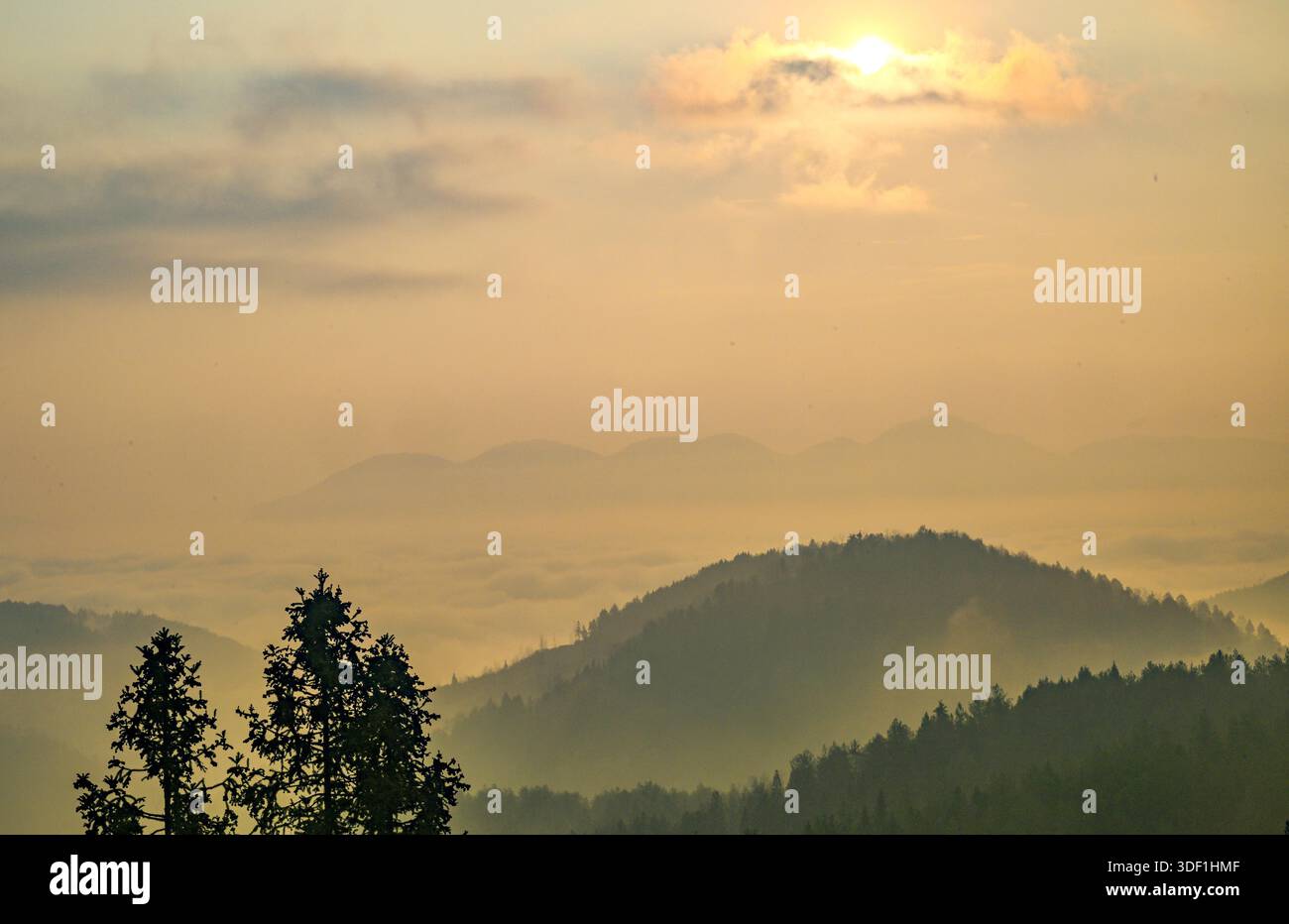 The morning sun rises over mountains as mist lingers in Dingshi Town ...
