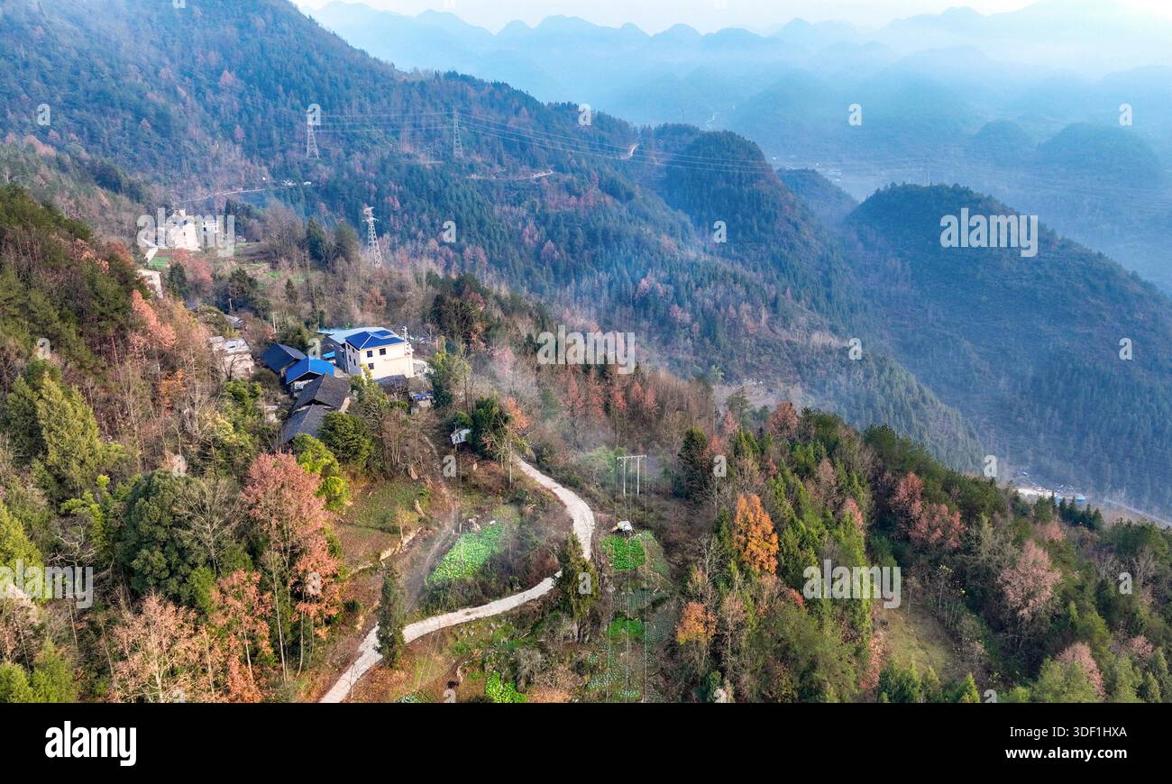 The morning sun rises over mountains as mist lingers in Dingshi Town ...