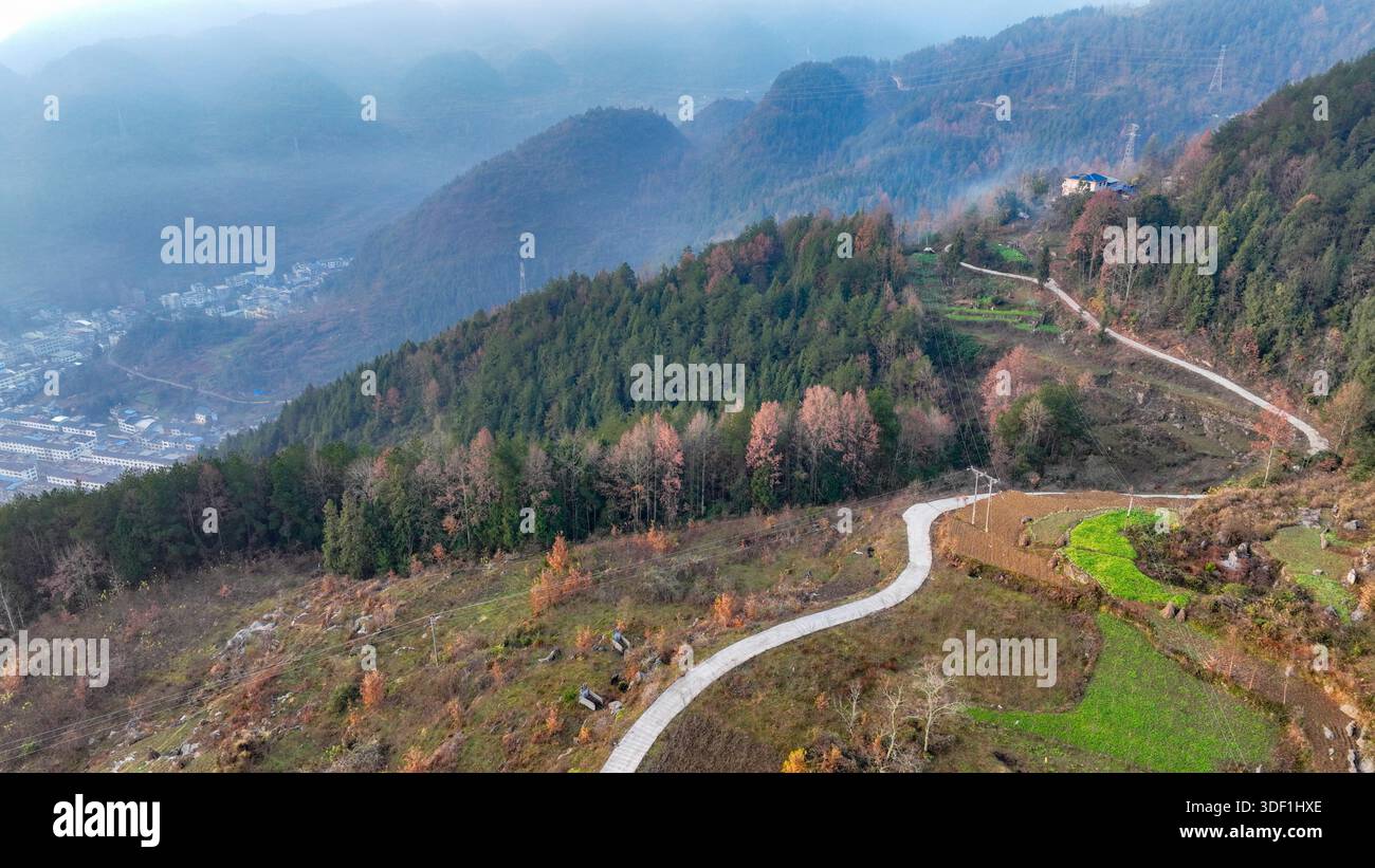 The morning sun rises over mountains as mist lingers in Dingshi Town ...