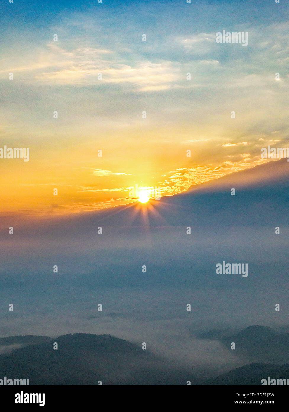 The morning sun rises over mountains as mist lingers in Dingshi Town ...