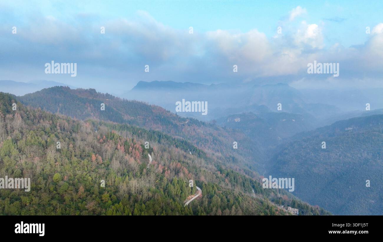The morning sun rises over mountains as mist lingers in Dingshi Town ...