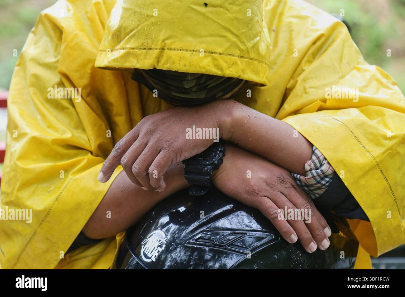 A woman waits as rescuers continue operations on a collapsed waste ...