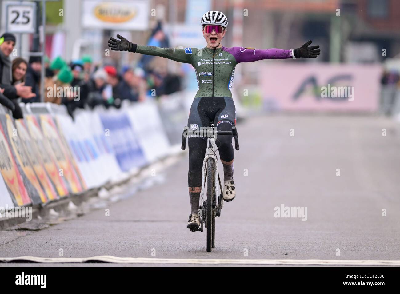 Belgian Liese Geuens celebrates as she crosses the finish line to win ...