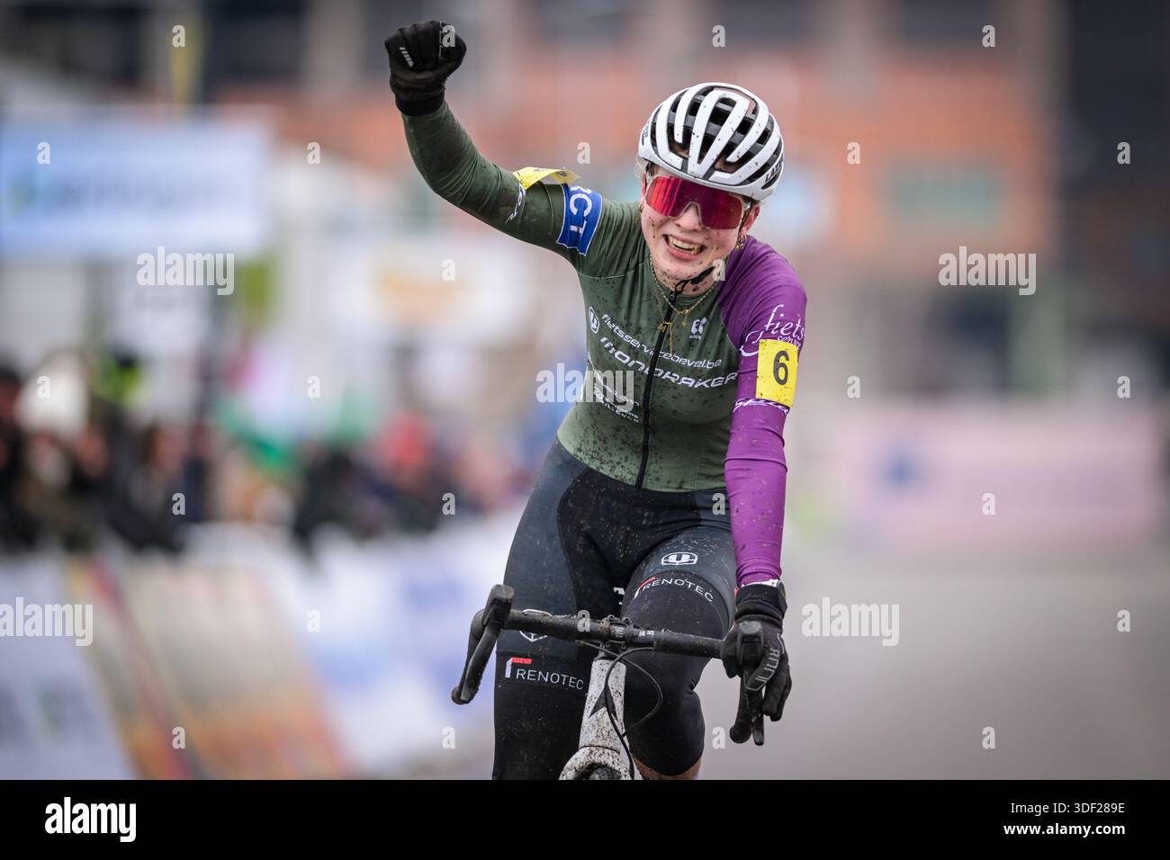 Belgian Liese Geuens celebrates as she crosses the finish line to win ...