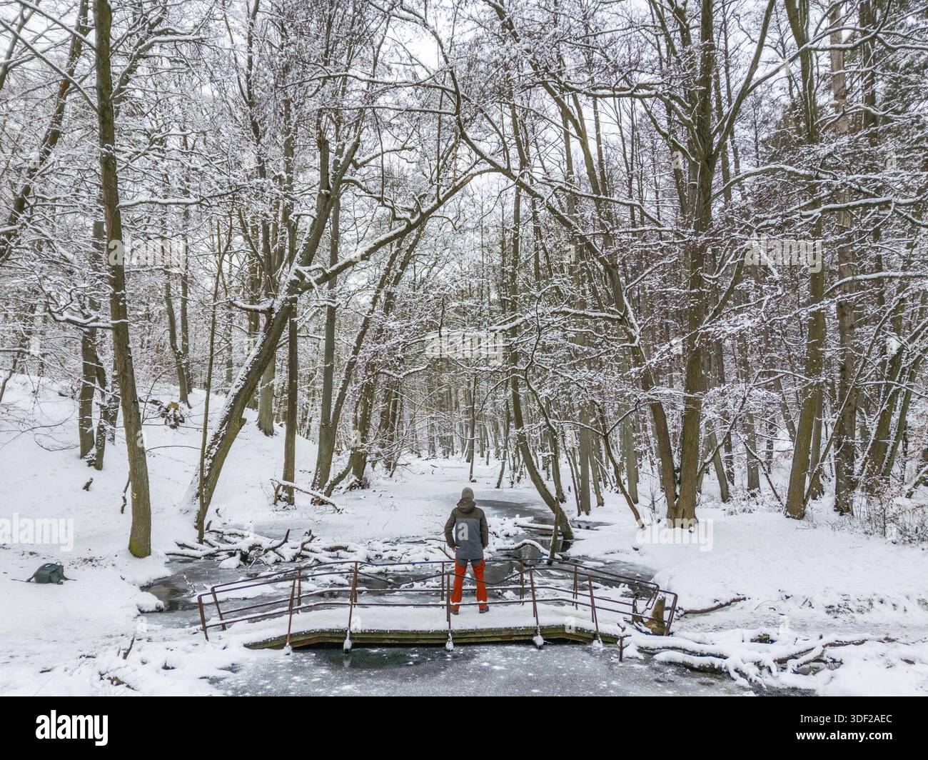 Aerial view, drone photo: Man hiking standing on a bridge over the ...