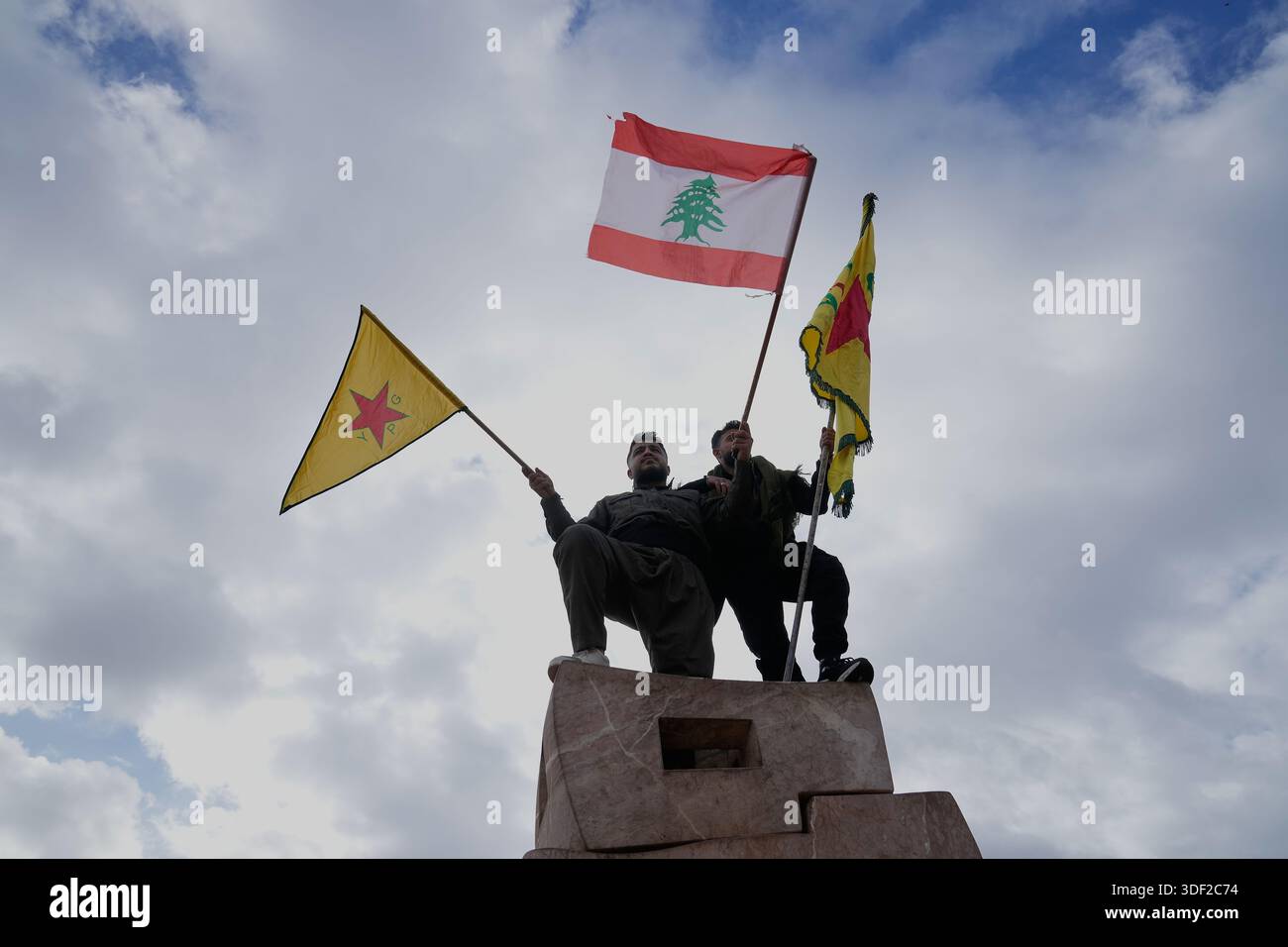 Kurdish citizens wave their group and Lebanese flags during a protest ...