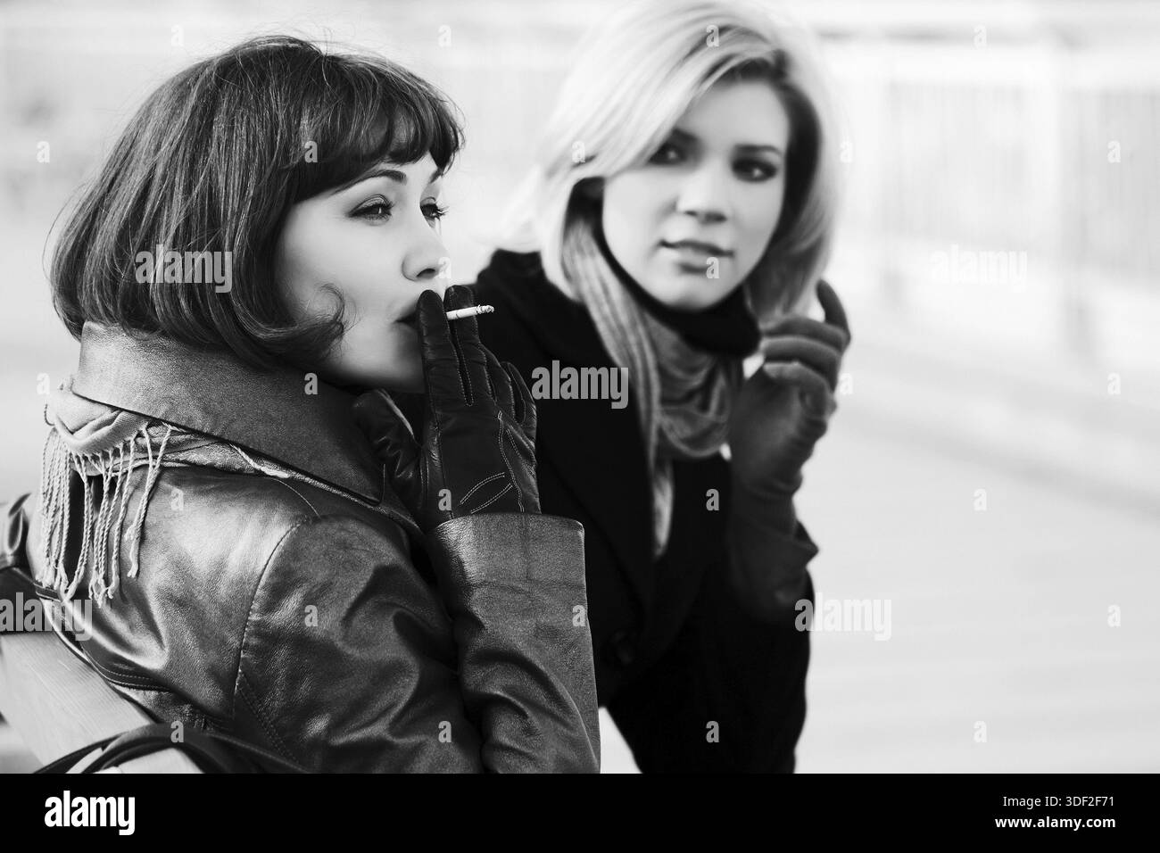 Two people smoking women Black and White Stock Photos & Images - Alamy