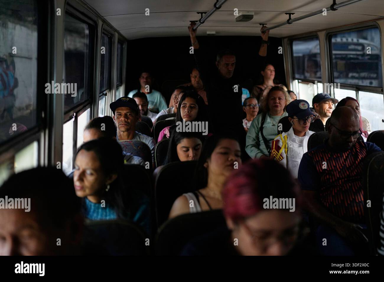 Commuters ride a bus in Caracas, Venezuela, Saturday, Jan. 10, 2026, a ...