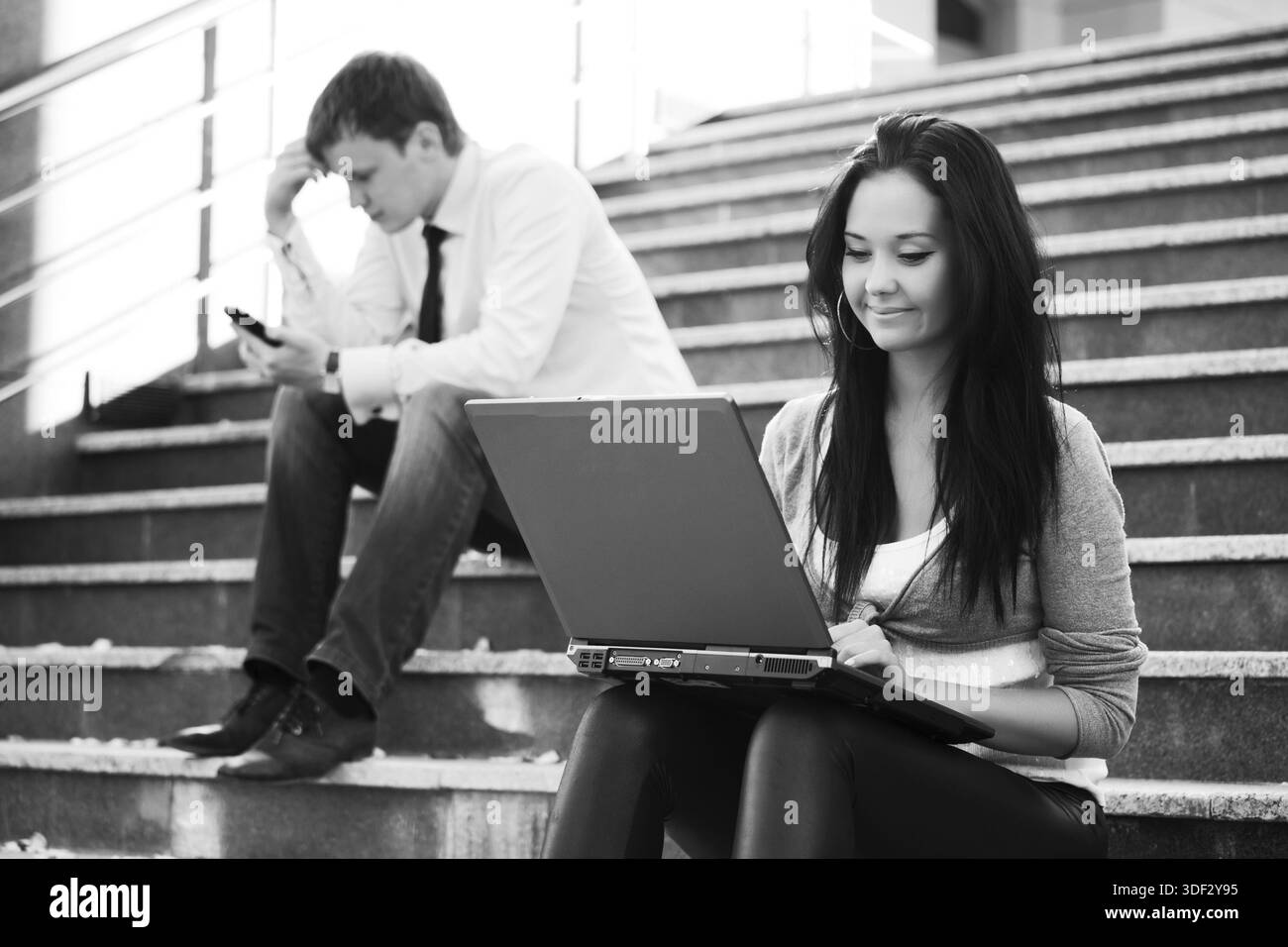 Young students on the steps of campus Stock Photo - Alamy