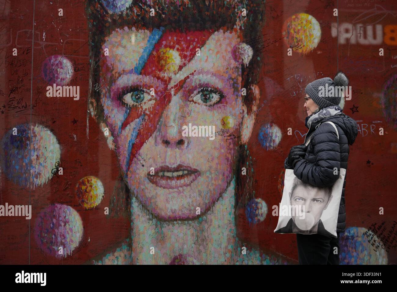 A fan looks at a mural on the 10th anniversary of the death of David ...