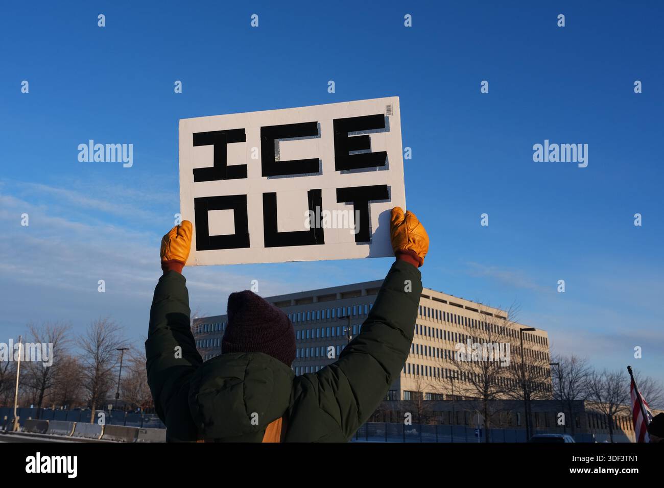 A protester holds up a sign outside the Bishop Henry Whipple Federal ...
