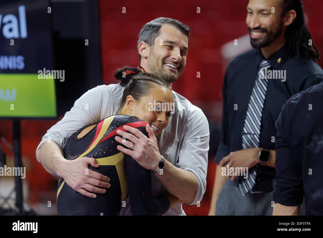 Maryland head coach Brett Nelligan congratulates gymnast Chelsey Dennis ...