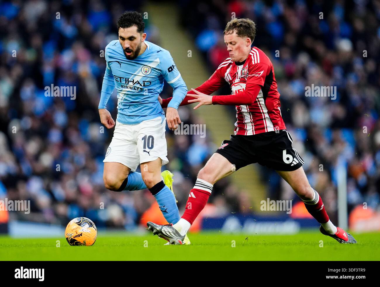 Manchester City's Rayan Cherki and Exeter City's Ethan Brierley (right ...