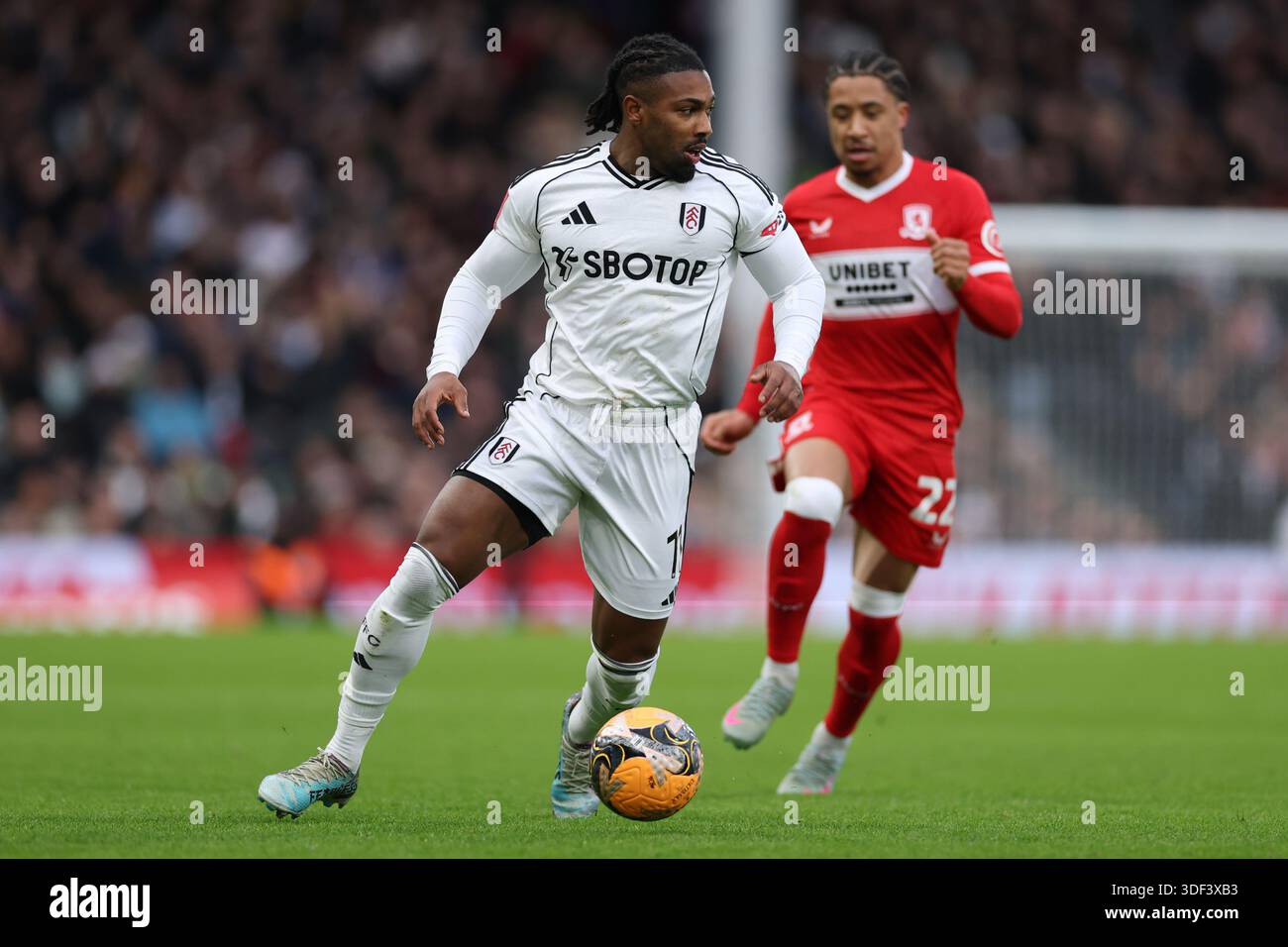 Adama Traoré of Fulham (left) under pressure by Sam Silvera of ...