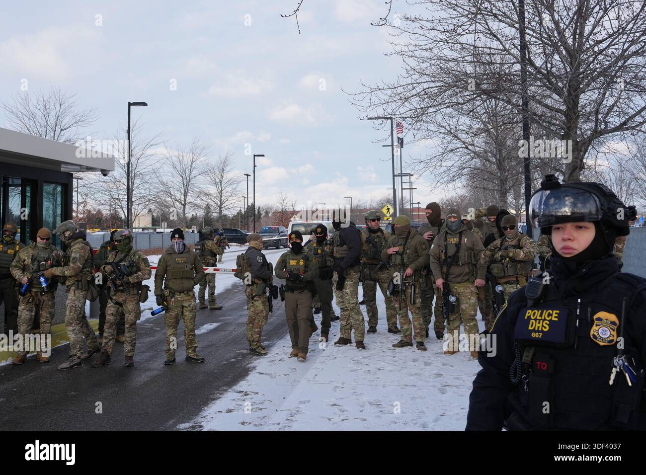 Federal agents stand outside the Bishop Henry Whipple Federal Building ...