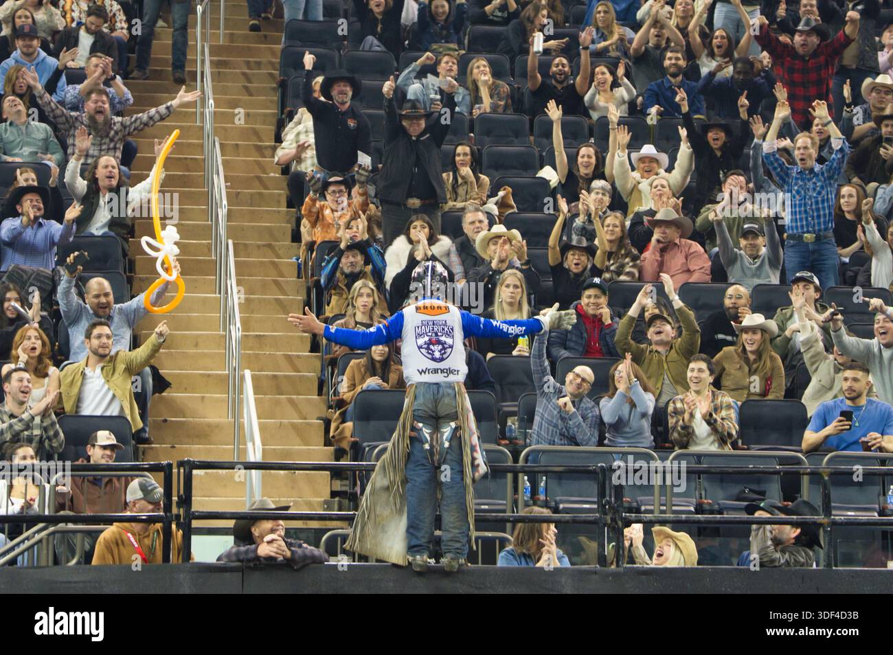 A bull rider in chaps and a vest with "New York Mavericks" on the back ...
