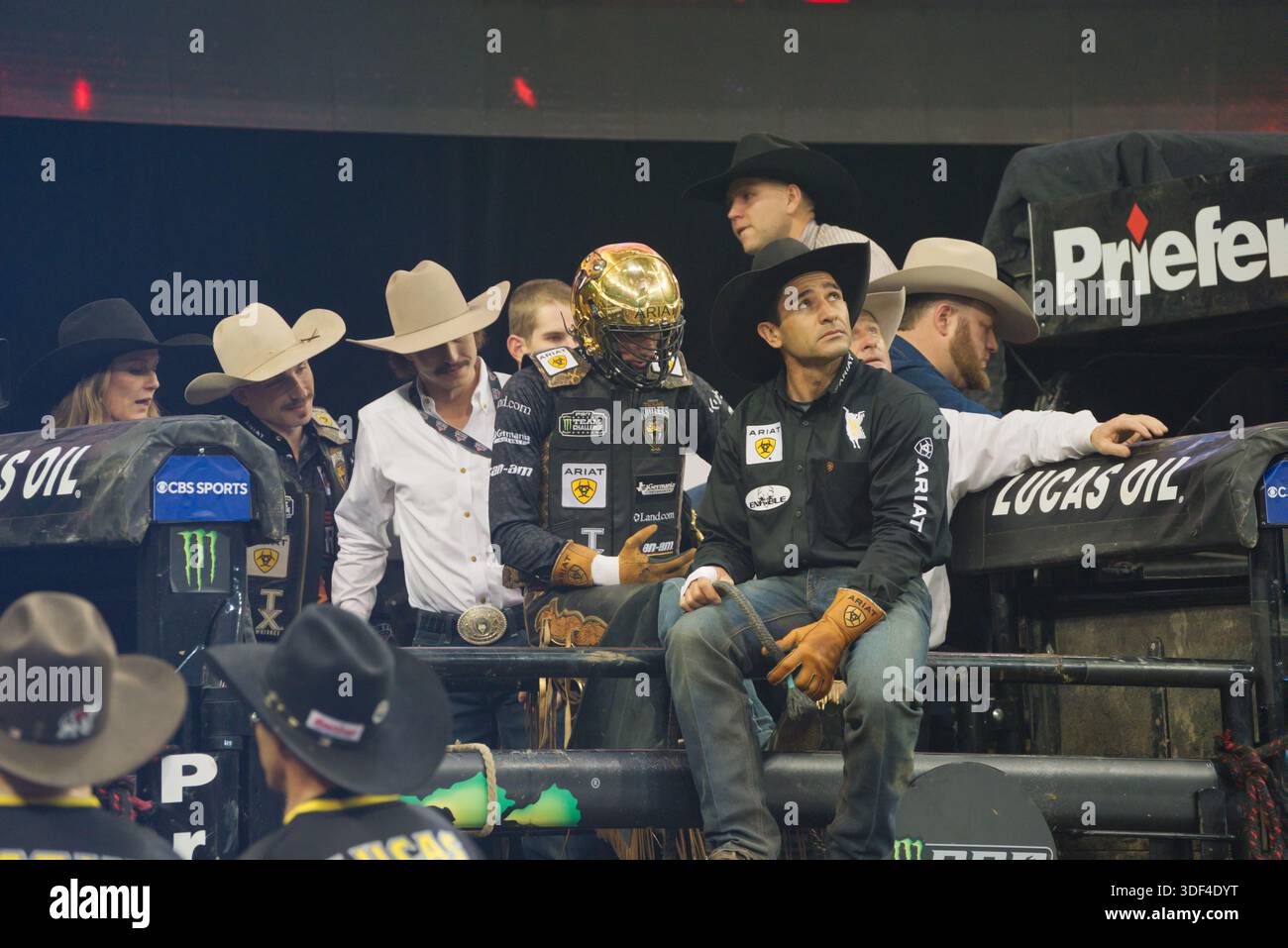 A group of rodeo participants wearing cowboy hats and protective gear ...