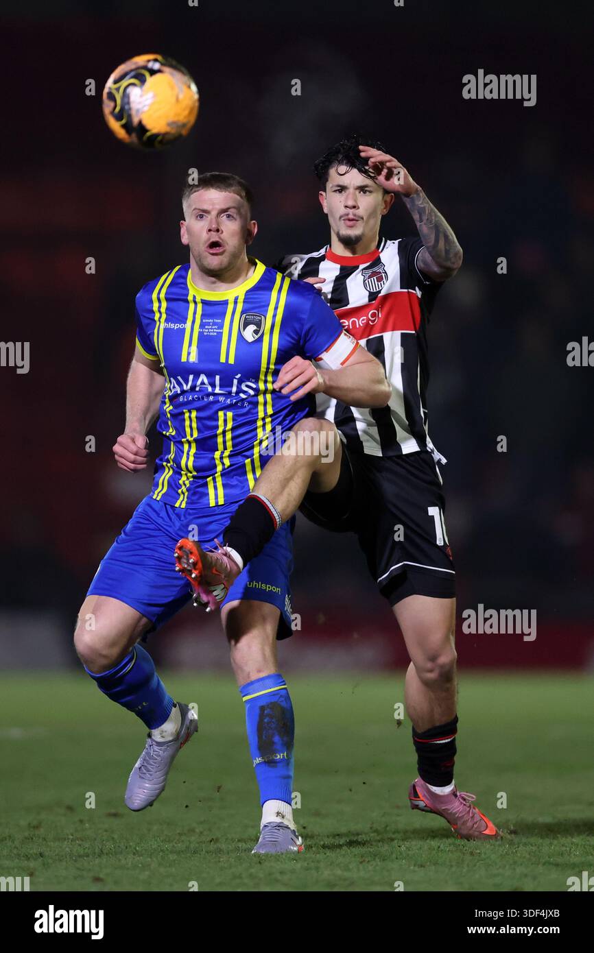 Weston-super-Mare's Emlyn Lewis (left) and Grimsby Town's Jude Soonsup ...