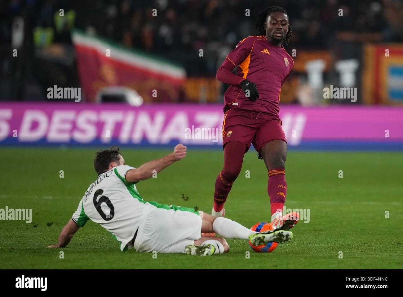 Sassuolo's Sebastian Walukiewicz tackles Roma's Manu Kone during a ...