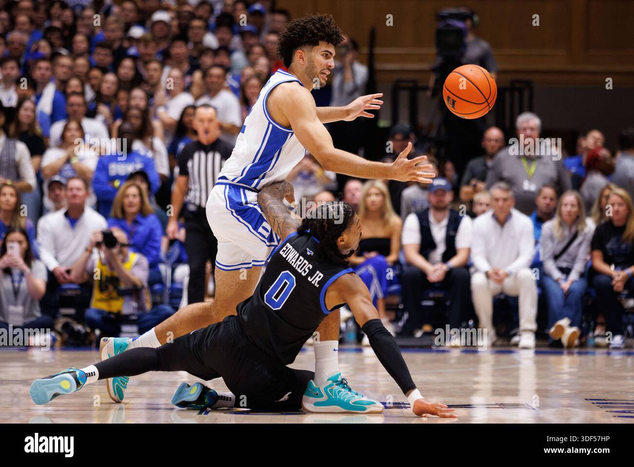 Duke's Cameron Boozer, left, and SMU's B.J. Edwards (0) chase a loose ...