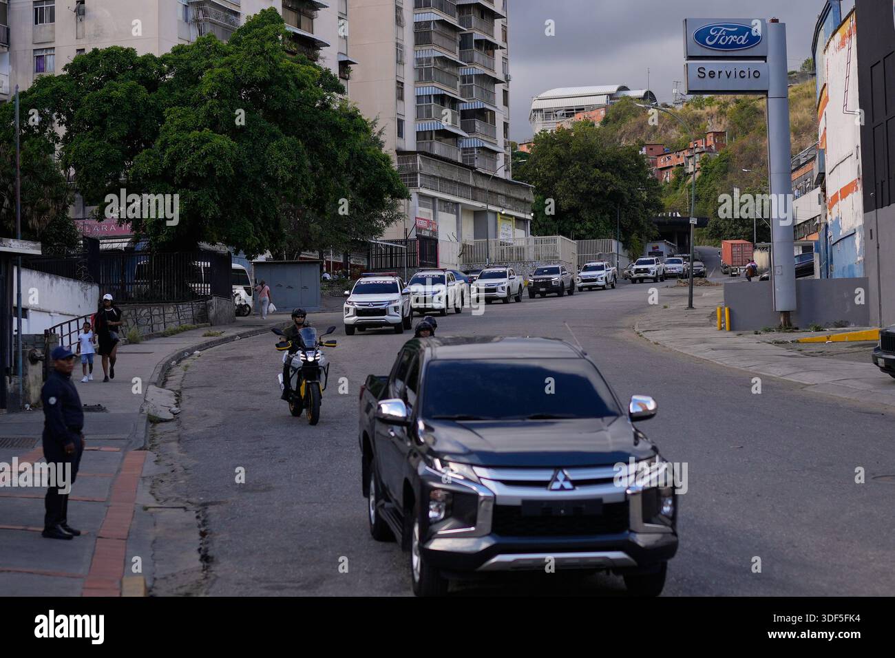 A caravan of police vehicles departs El Helicoide, headquarters of ...