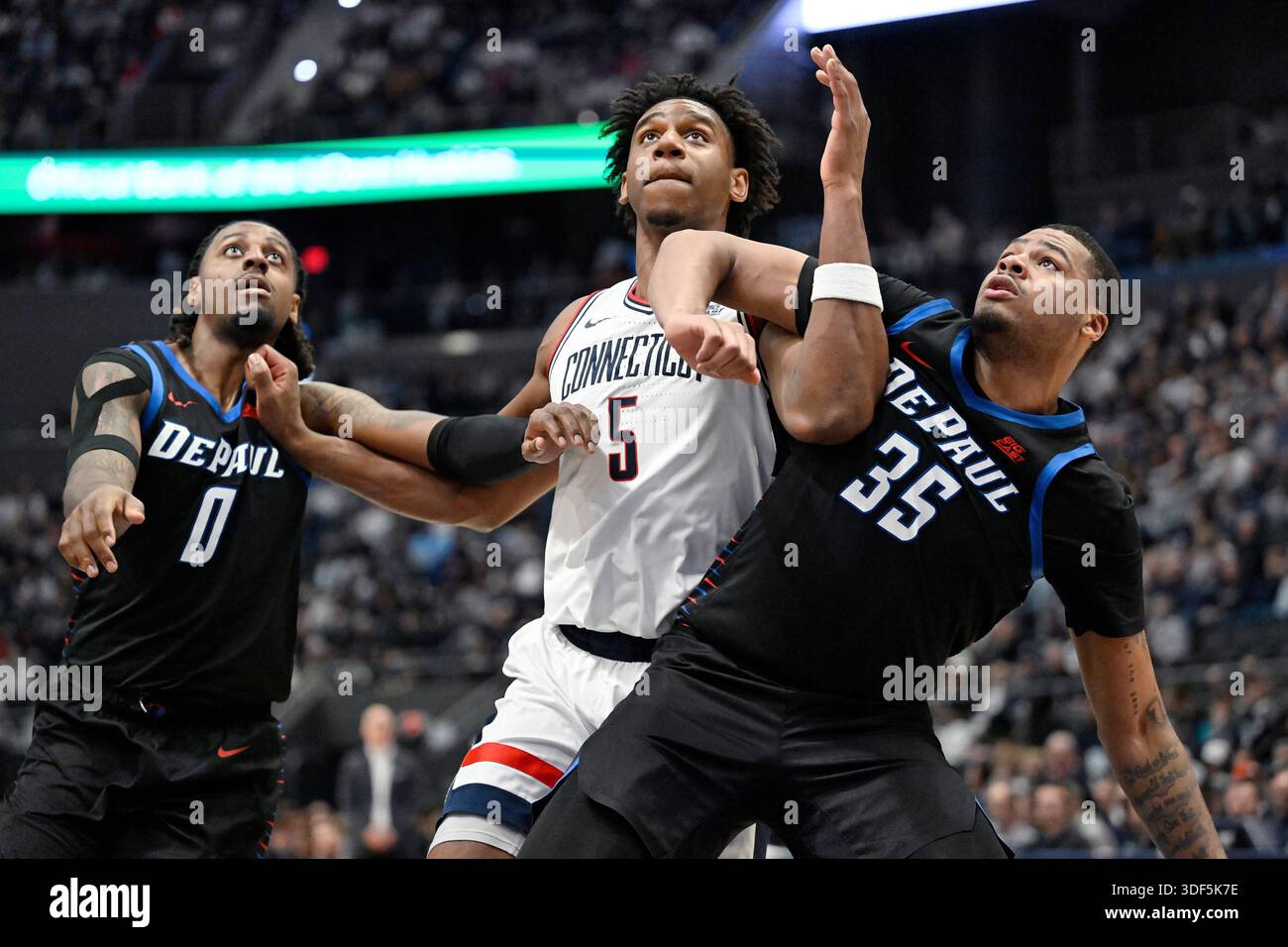 DePaul guard Brandon MacLin (0), UConn forward Tarris Reed Jr. (5), and ...