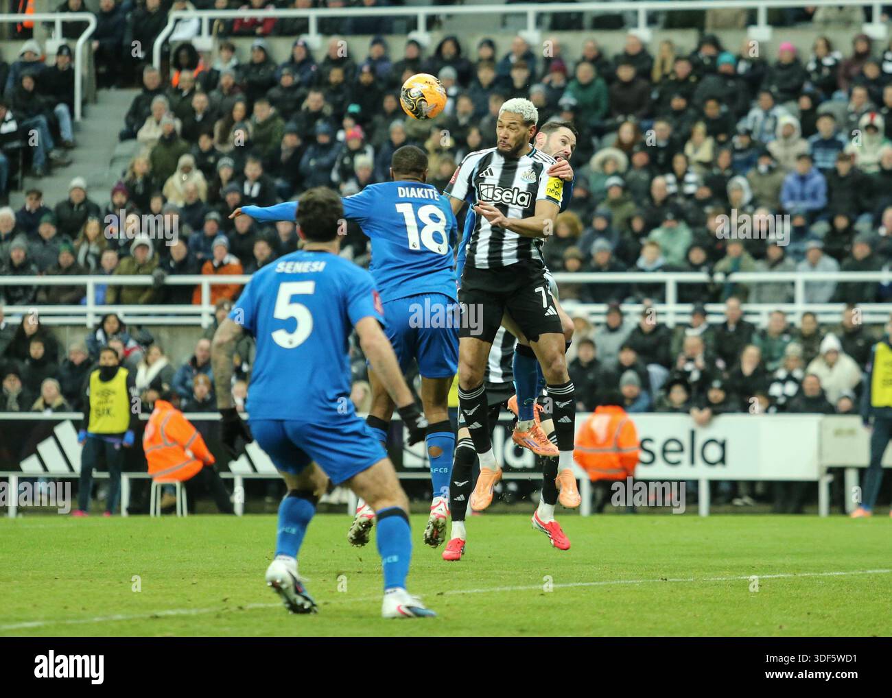 Joelinton of Newcastle United jumps up to win the high ball during the ...
