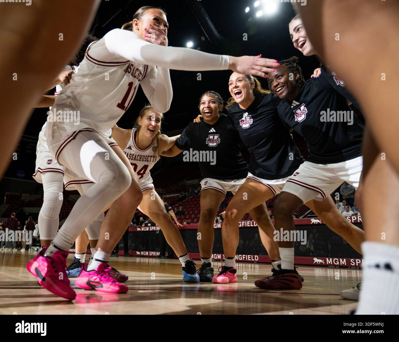 Massachusetts players cheer in a huddle before an NCAA college ...