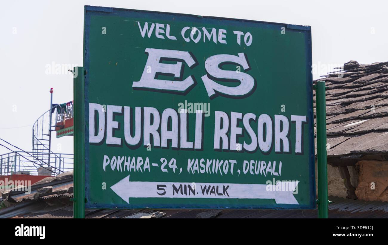 Green and white directional sign for a resort, providing guidance and ...