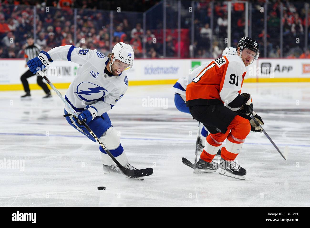 Tampa Bay Lightning's Brandon Hagel, left, skates with the puck past ...