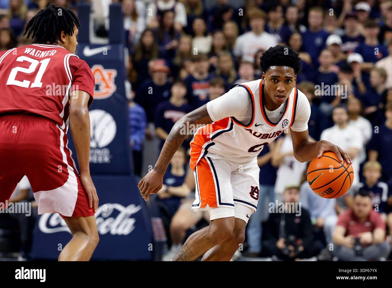 Auburn guard Tahaad Pettiford dribbles around Arkansas guard D.J ...