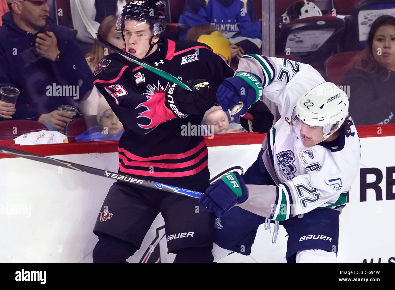 Seattle Thunderbirds RW Simon Lovsin, rt, gets tangled up with Calgary ...
