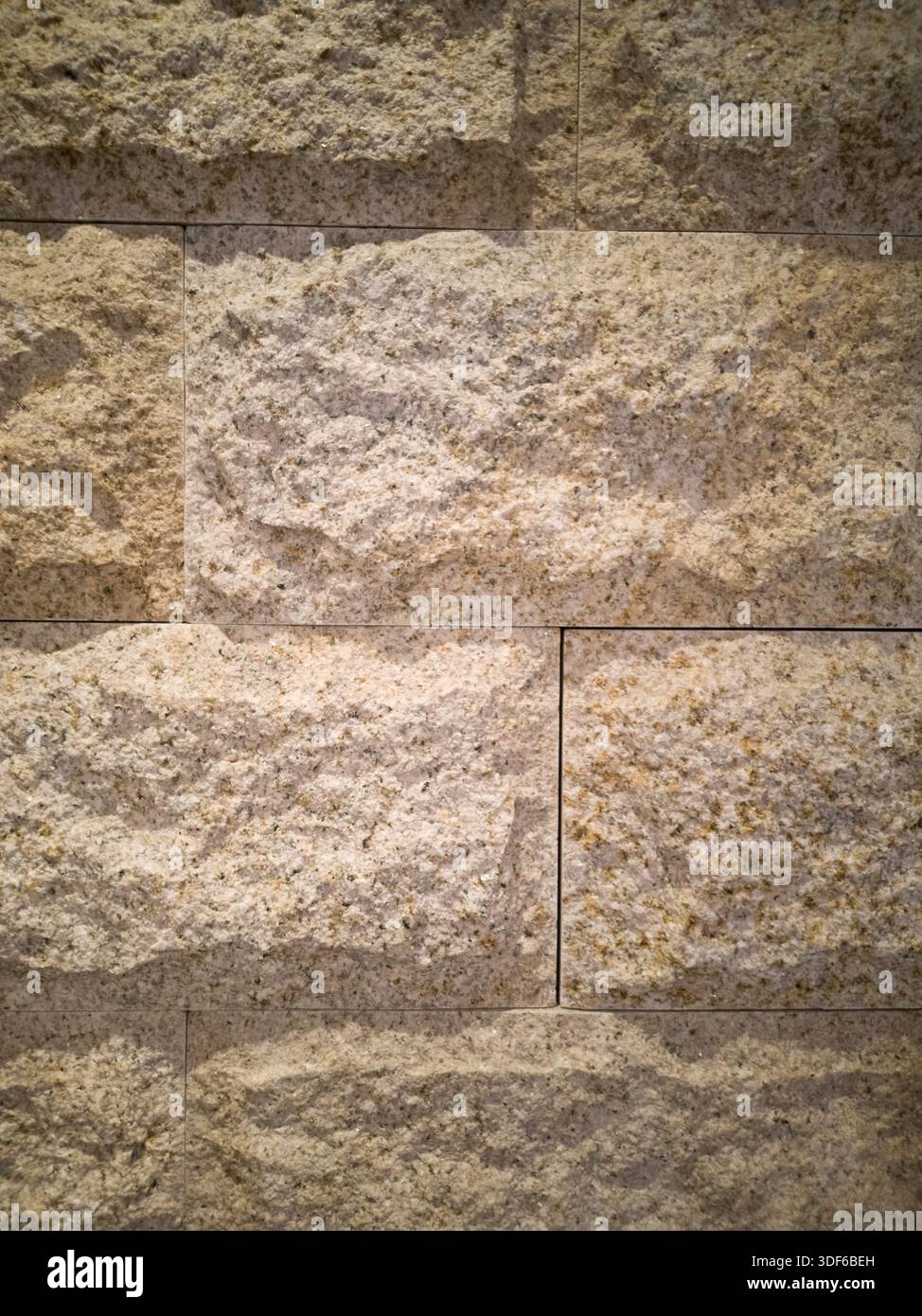 Granite stone wall texture with rough cut blocks and natural surface ...