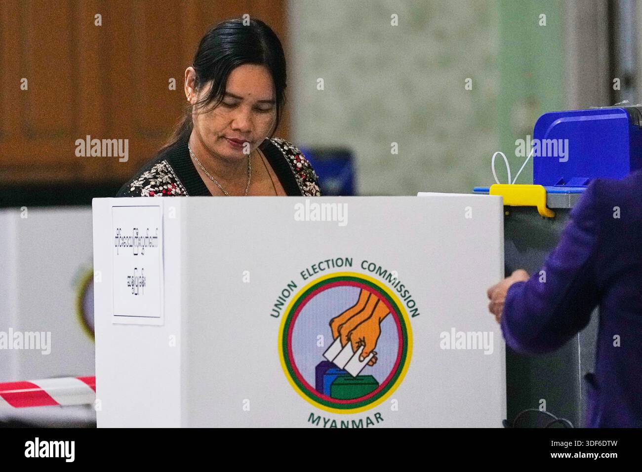 A voter casts ballot at a polling station during the second phase of ...